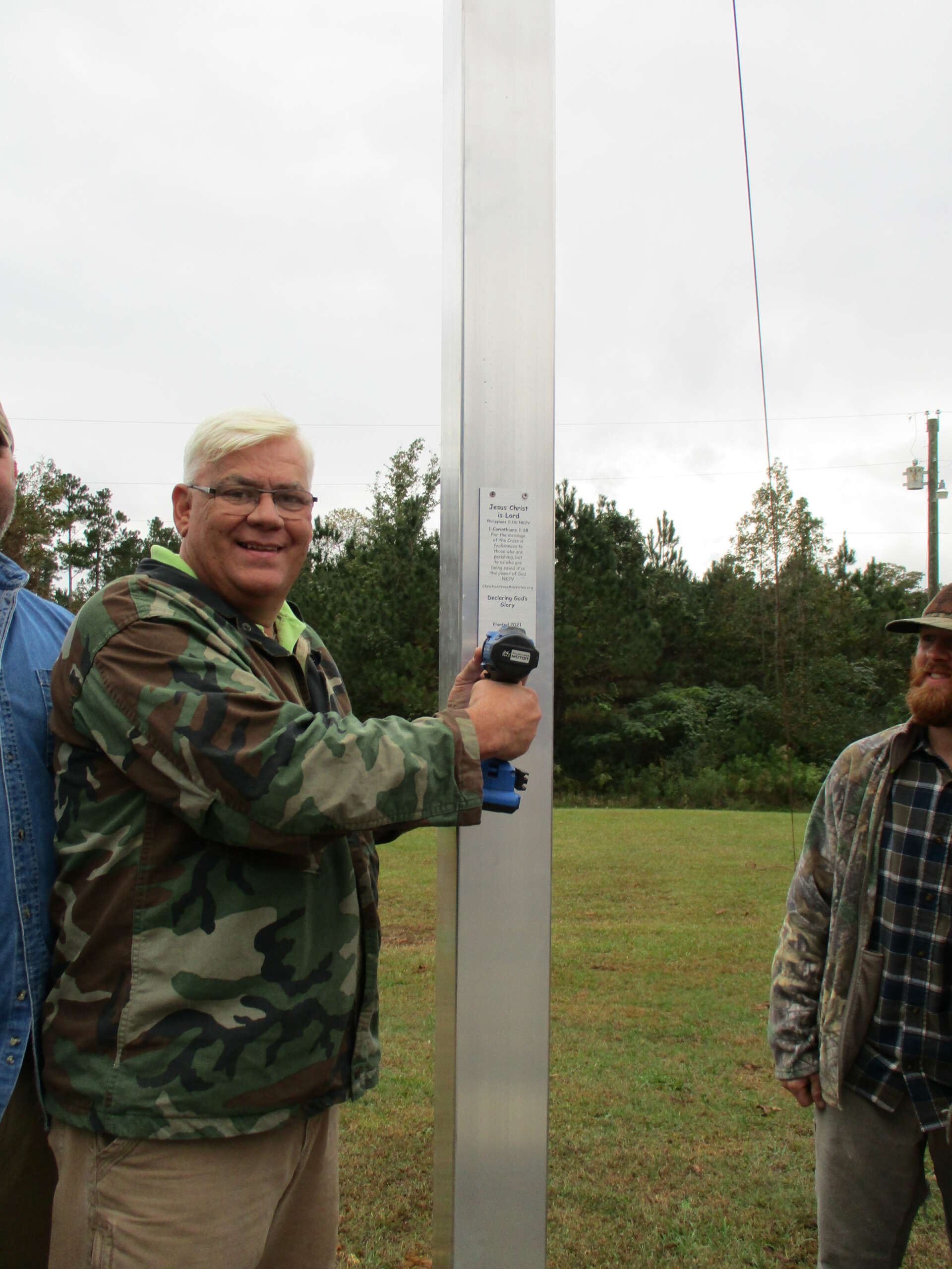 Pastor Tony Attaching Plaque | Christian Cross Ministries