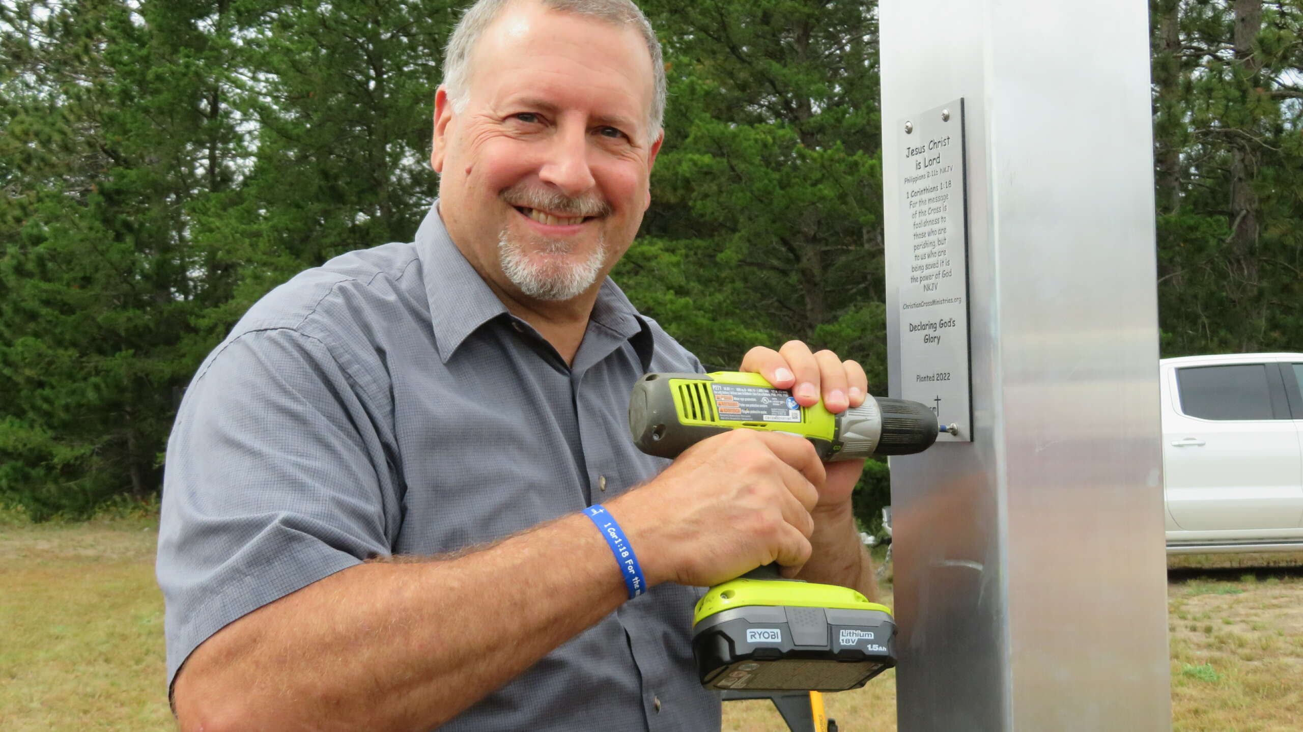Pastor Charlie Bolstridge Attaching Plaque | Christian Cross Ministries